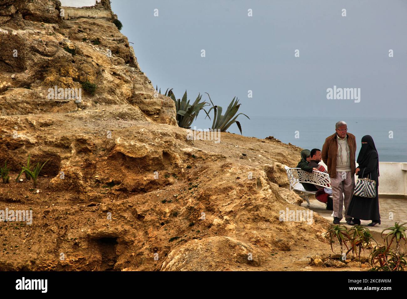 Arab couple walks towards the entrance to the Caves of Hercules ...