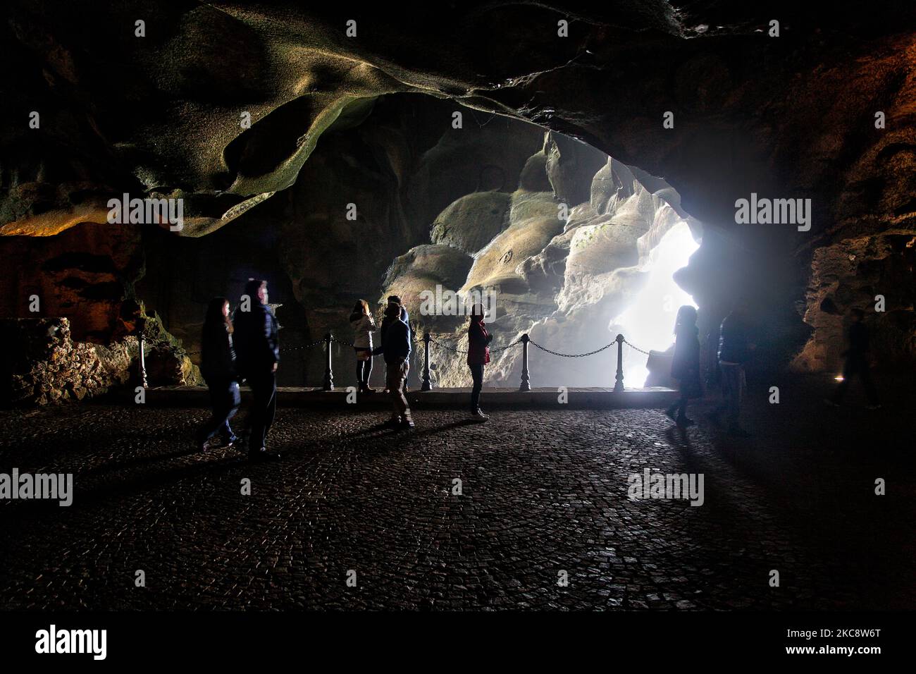 Tourists walk through the Caves of Hercules (Grottes d'Hercule) in ...