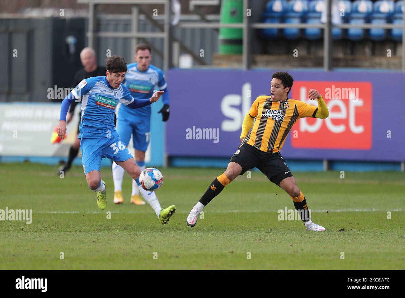 Jamie Devitt of Barrow in action with Kyle Knoyle of Cambridge United ...