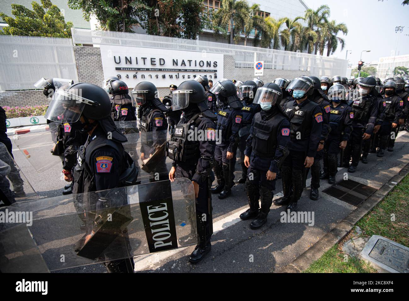 Riot police with riot-gear stand guard outside during a protest against ...