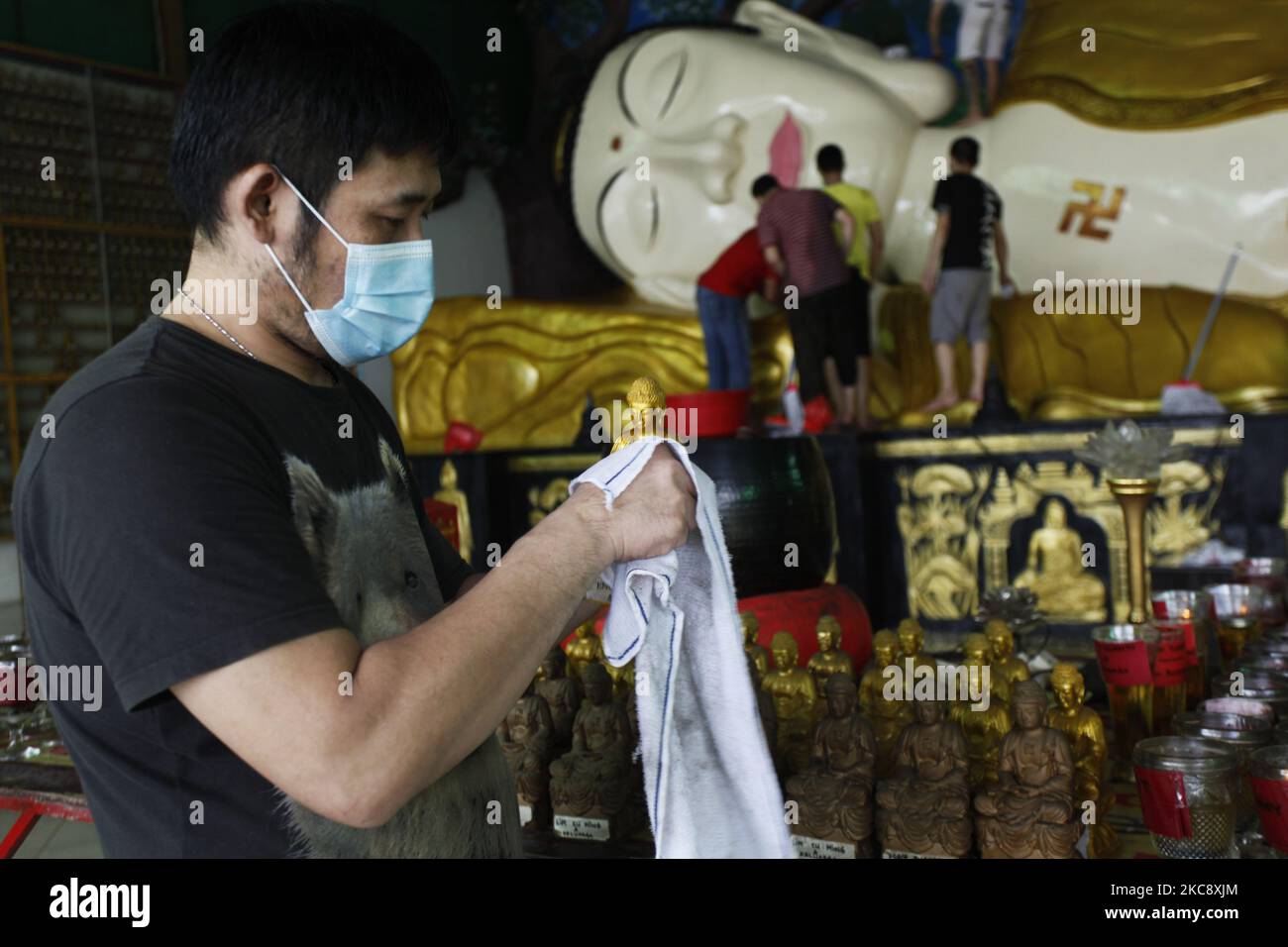 A Devotees clean statues of god at a temple in Bogor, West Java on ...