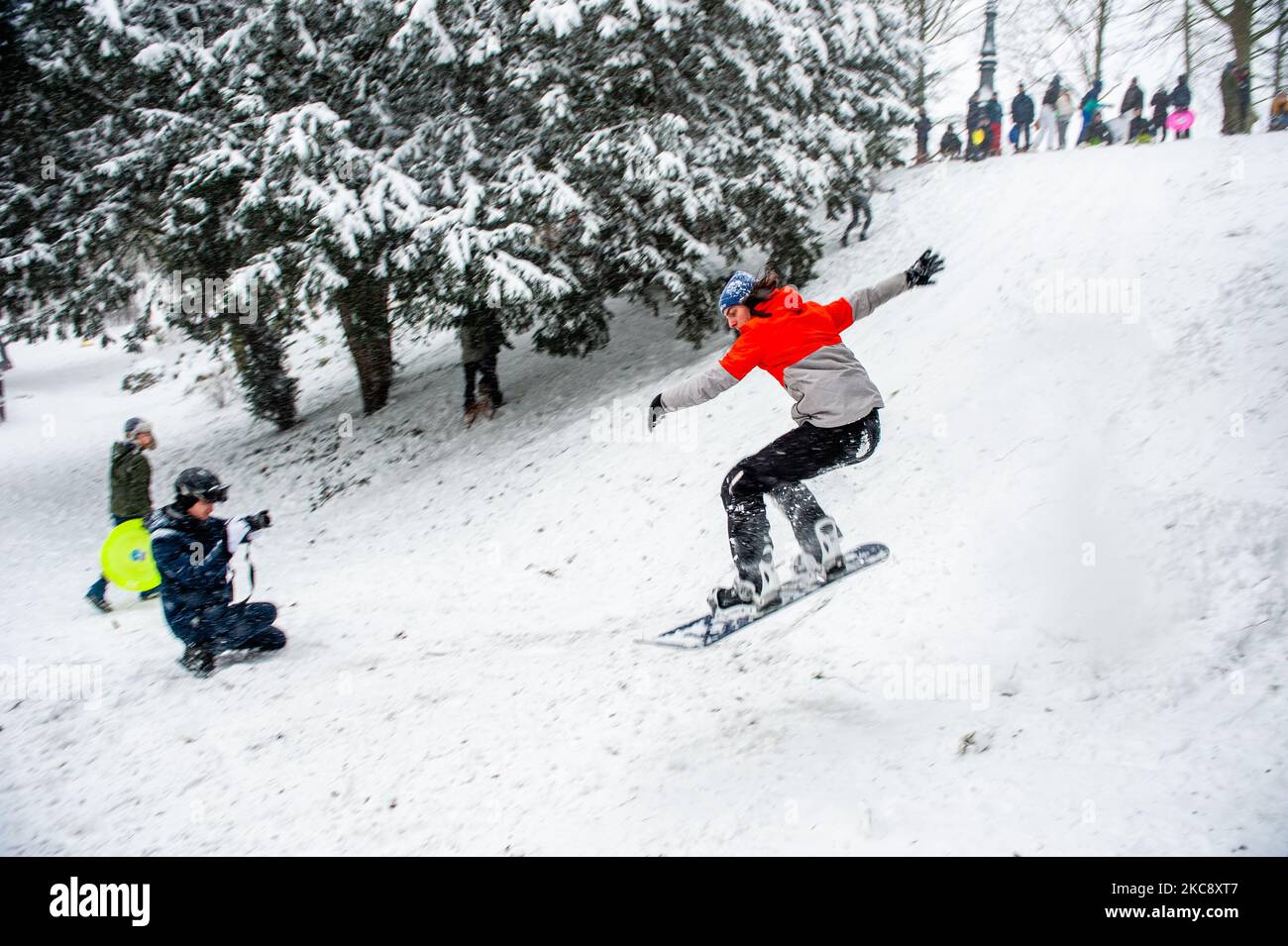 A man is snowboarding at the snowed park, during the snowstorm called ...