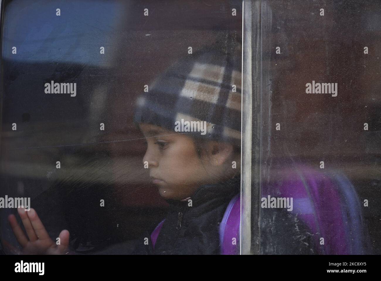 A School children look from his school bus in Bhaktapur, Nepal on ...