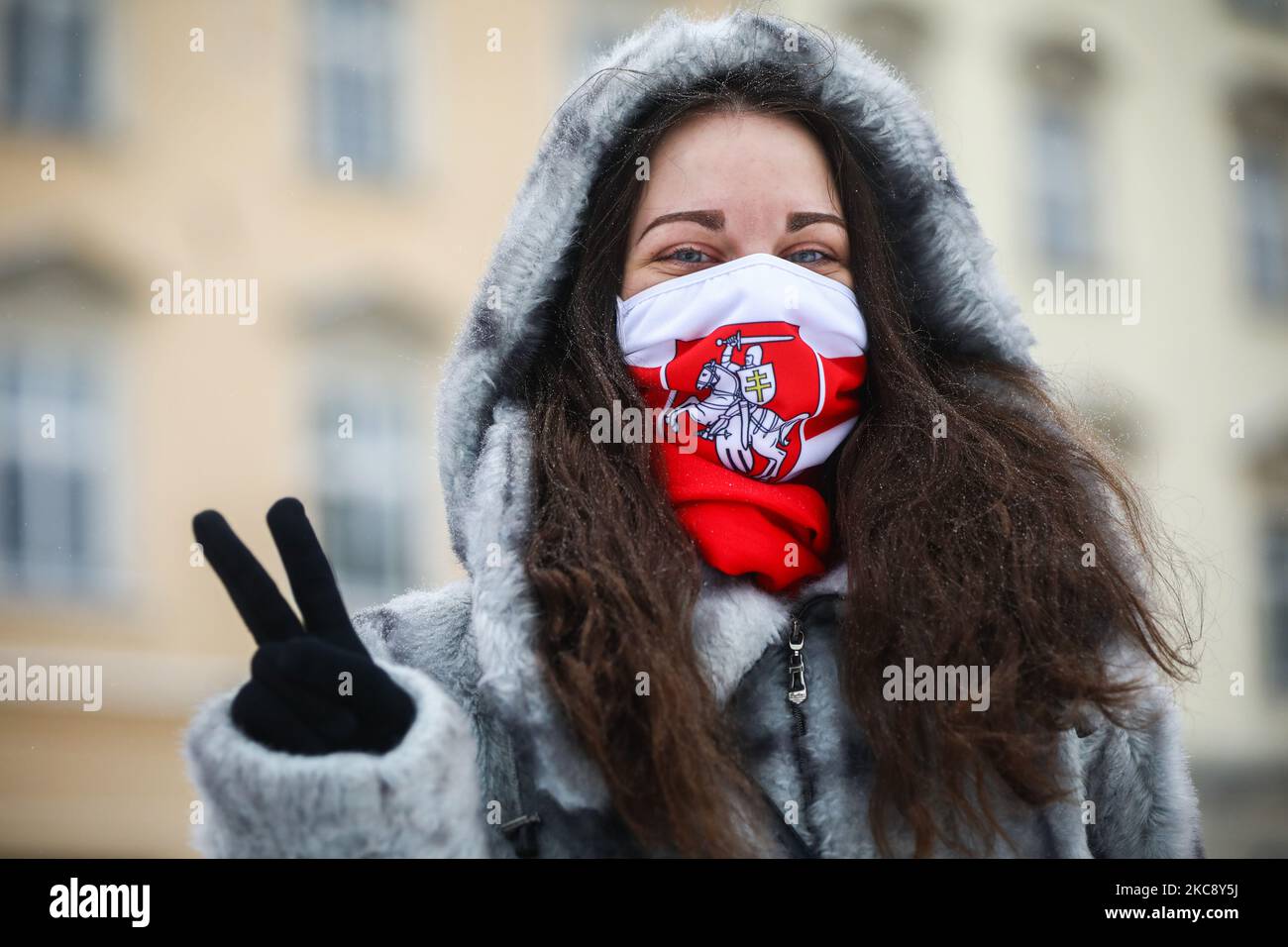 A young woman wears a face mask with Belarusian flag during a ...