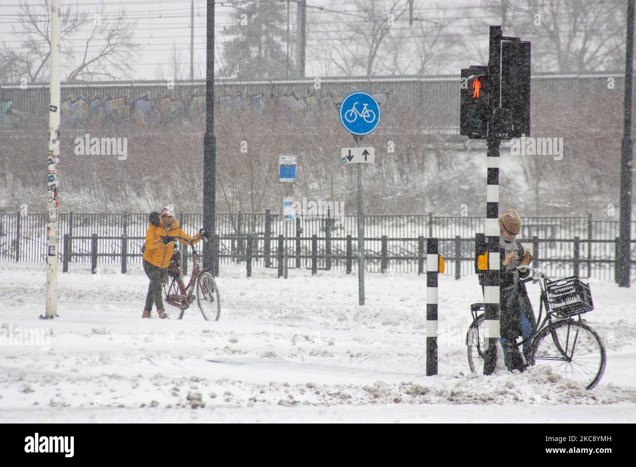 People as seen carrying their bicycles because of the difficulty of ...