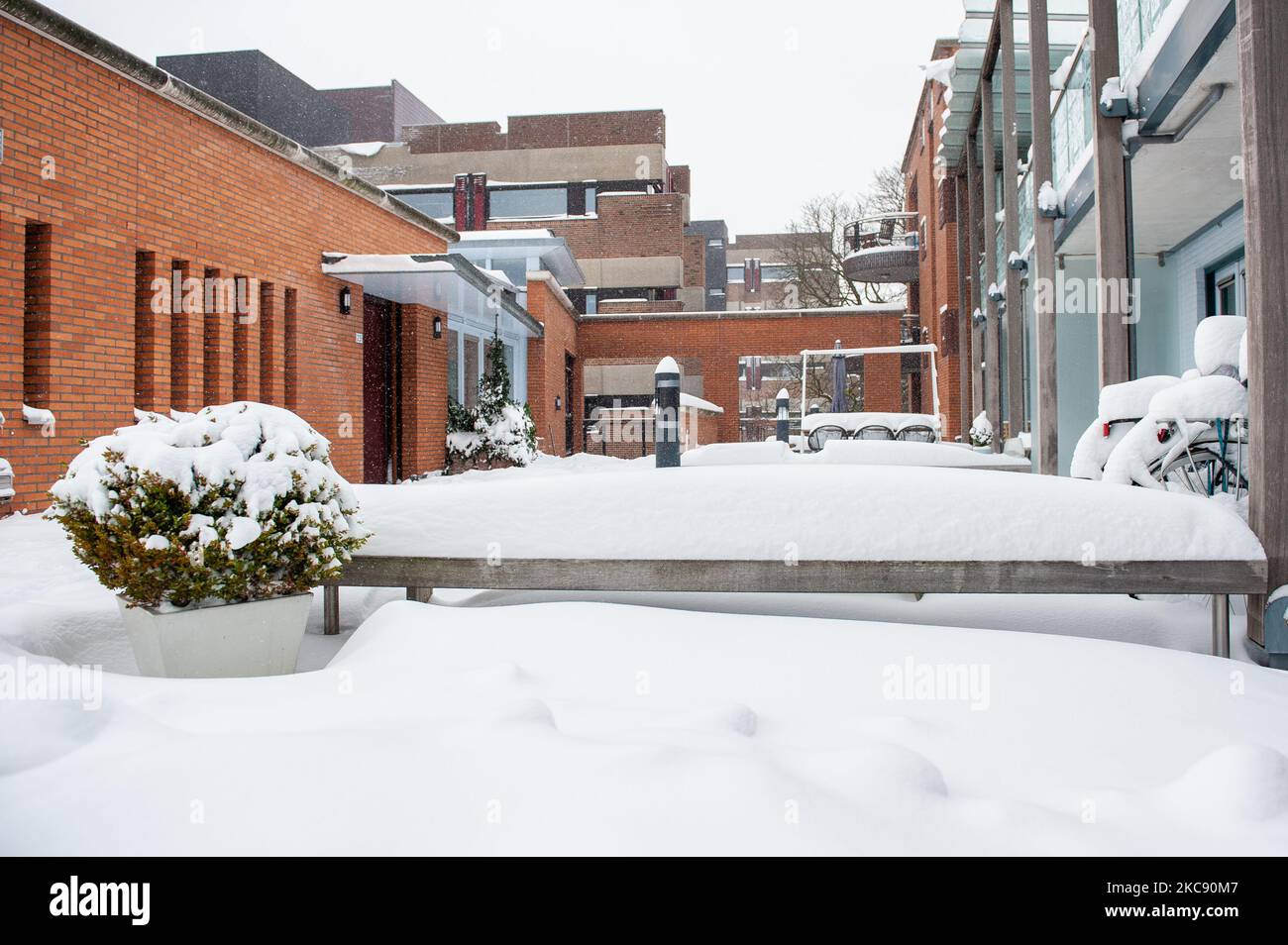 A view of a terrace full with snow, A man has just finished to remove ...