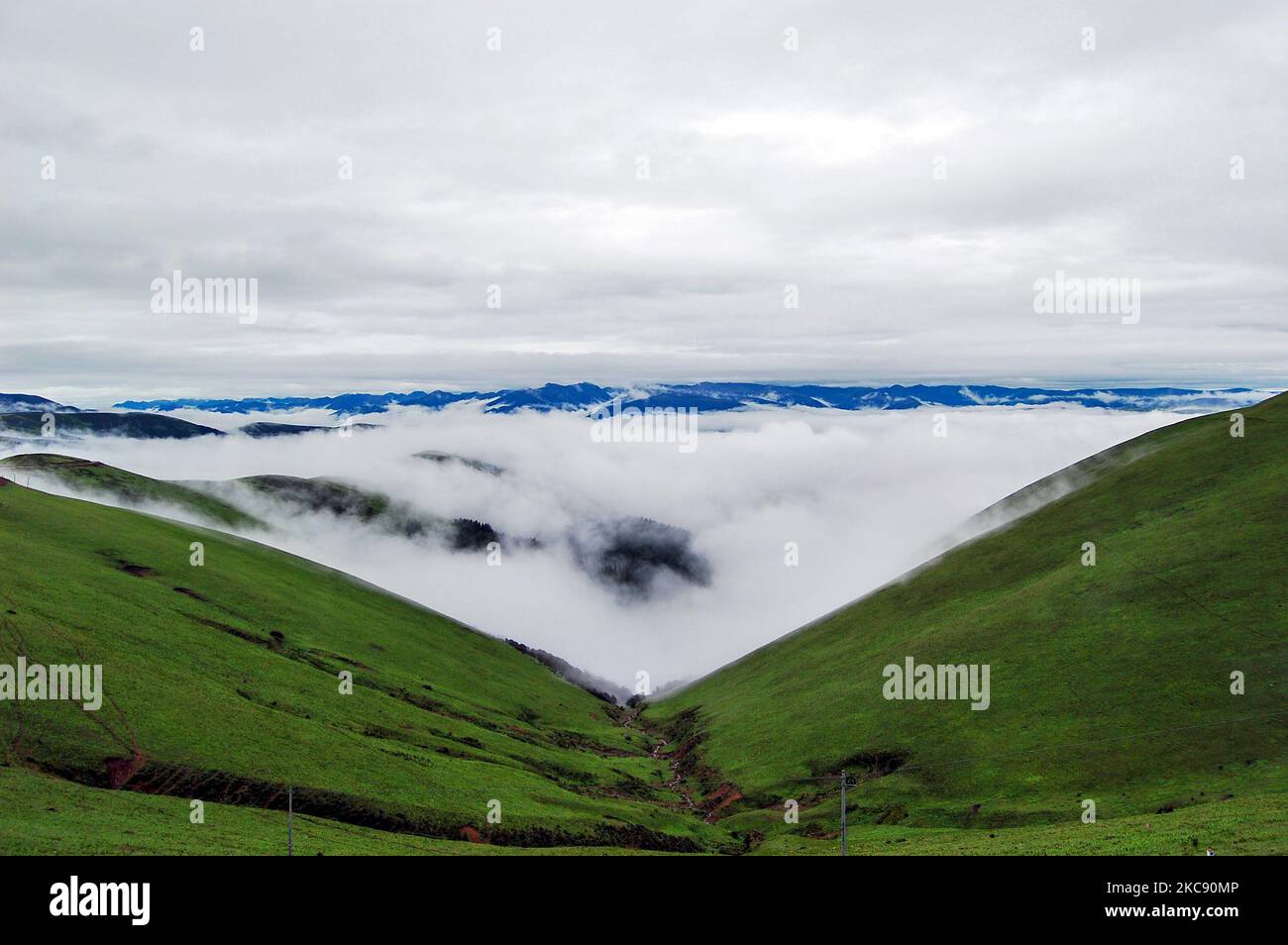 A beautiful view of a green hill with a cloudy sky background Stock ...