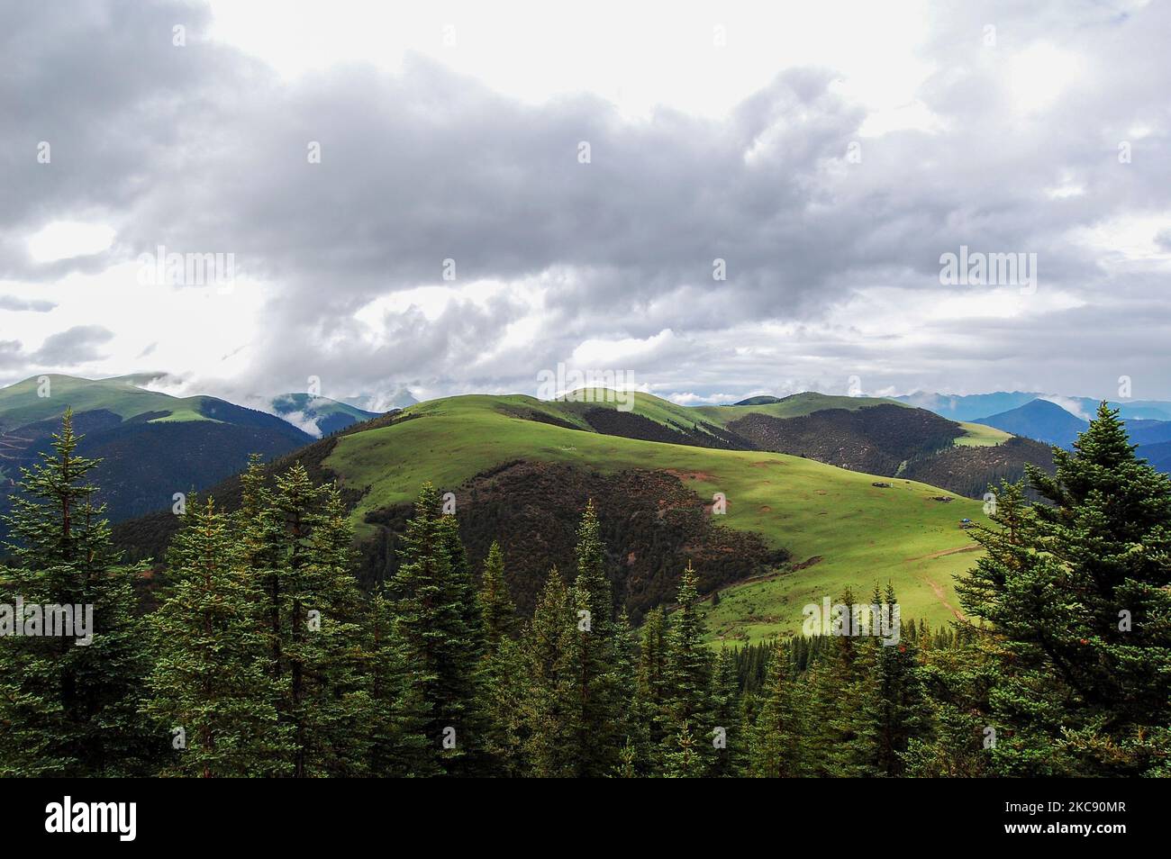 A beautiful view of a green hill with a cloudy sky background Stock ...