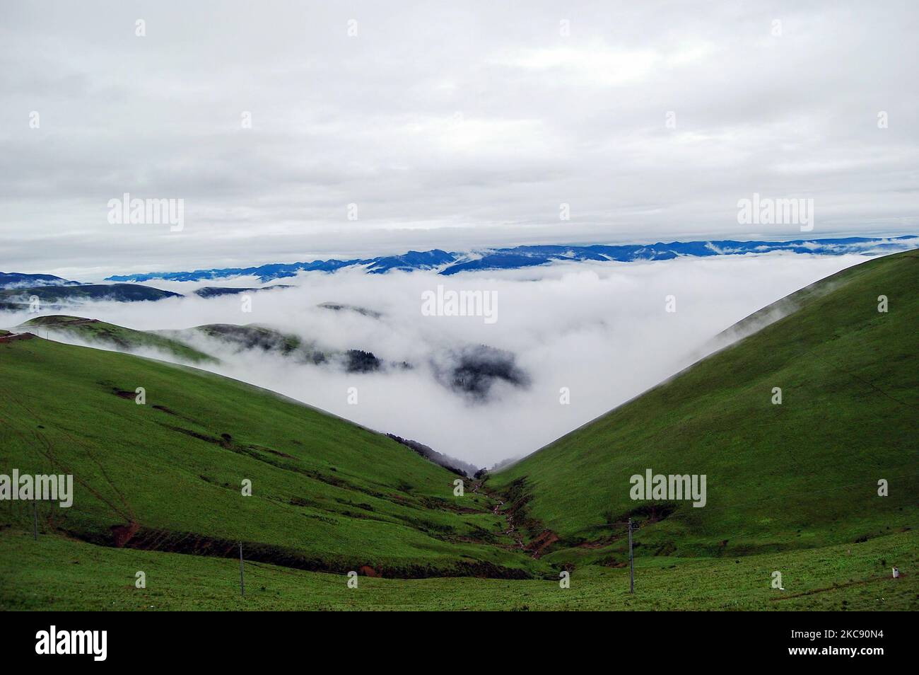 A beautiful view of a green hill with a cloudy sky background Stock ...