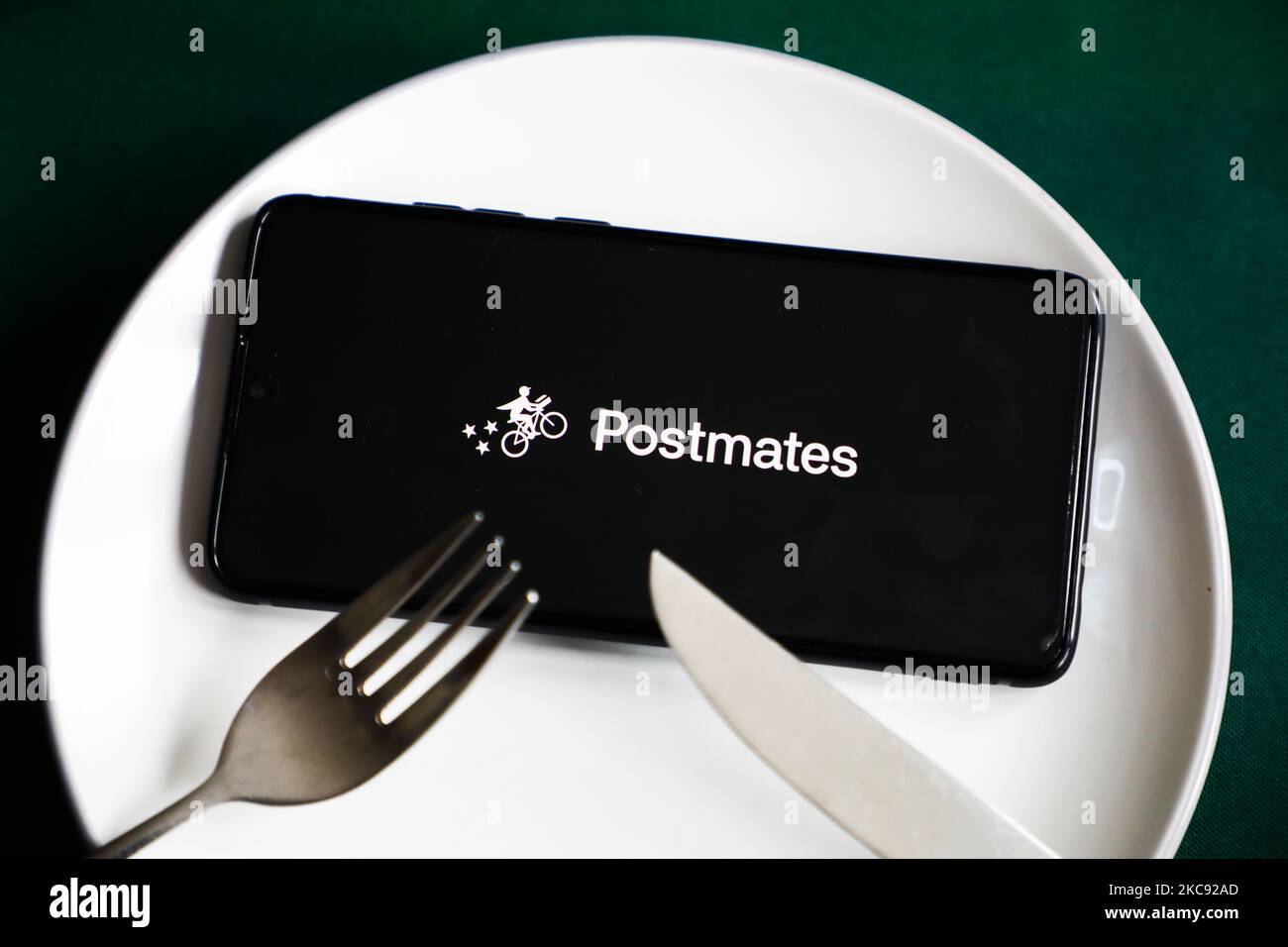 Just Eat app logo is displayed on a mobile phone screen photographed ...