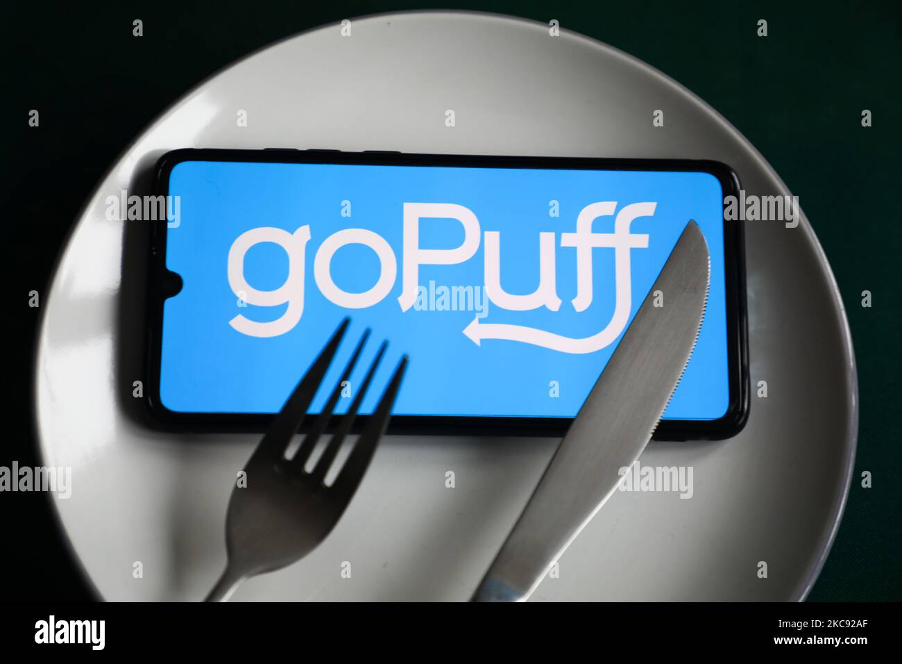 GoPuff app logo is displayed on a mobile phone screen photographed for ...