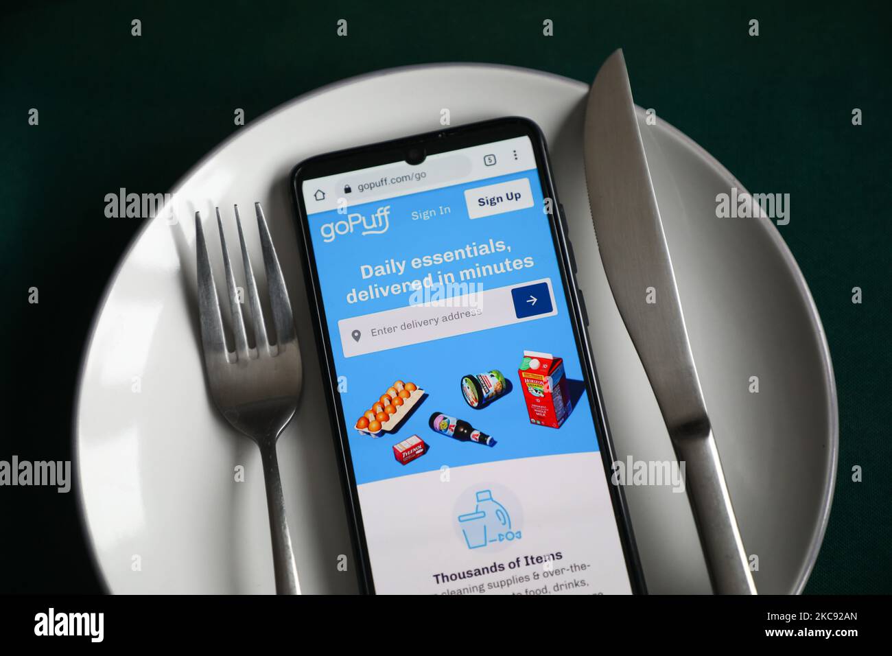 GoPuff app logo is displayed on a mobile phone screen photographed for ...