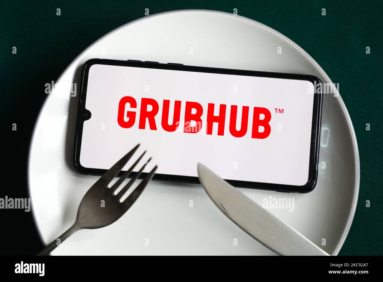 Grubhub app logo is displayed on a mobile phone screen photographed for ...