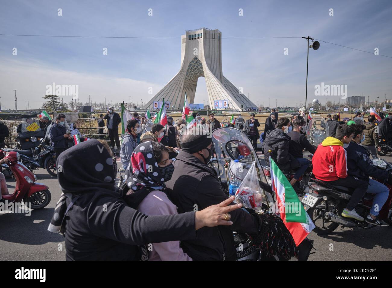 An Iranian family ride their motorcycle during a rally to commemorate ...