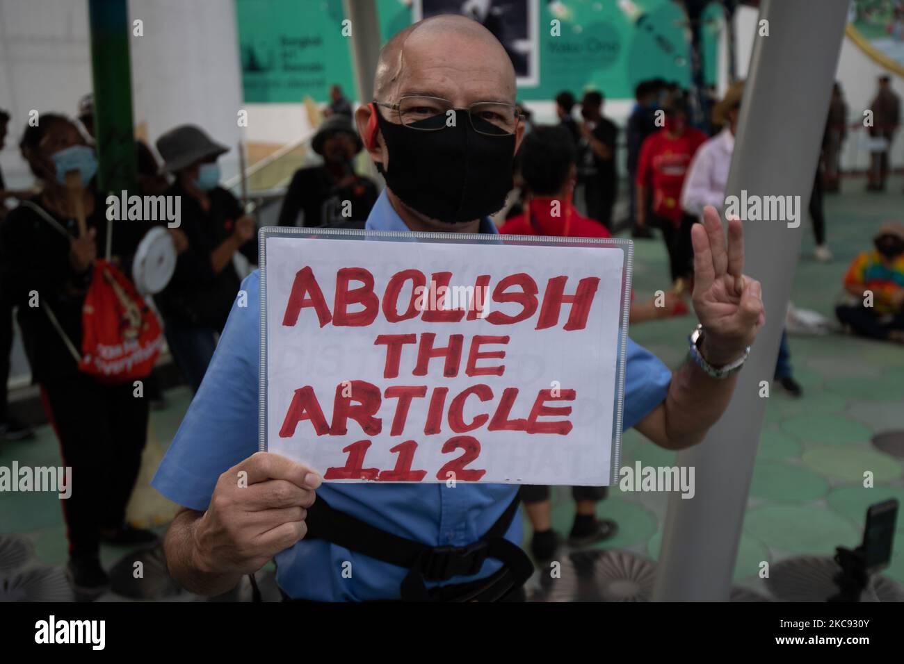 A pro-democracy protester holds up a placard during a protest demanding ...