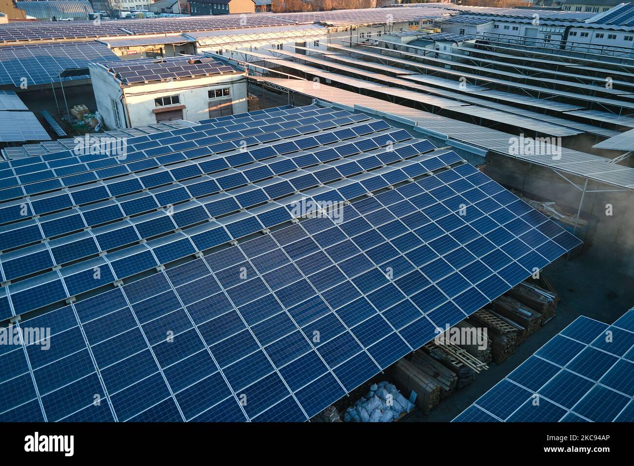 Aerial view of solar power plant with blue photovoltaic panels mounted ...
