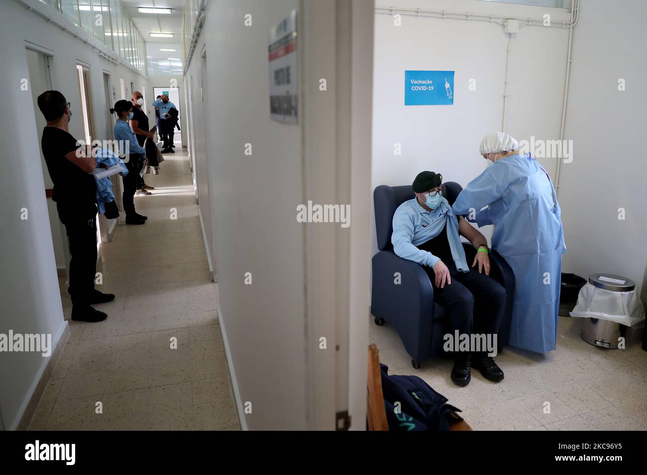 A National Republican Guard officer receives a first dose of the ...