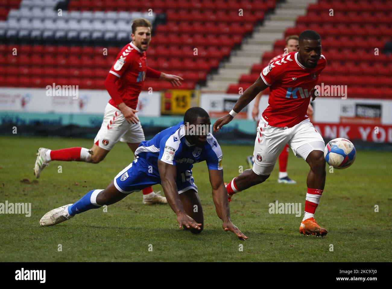 L-R John Akinde of Gillingham's beats Charlton Athletic's Deji Oshilaja ...