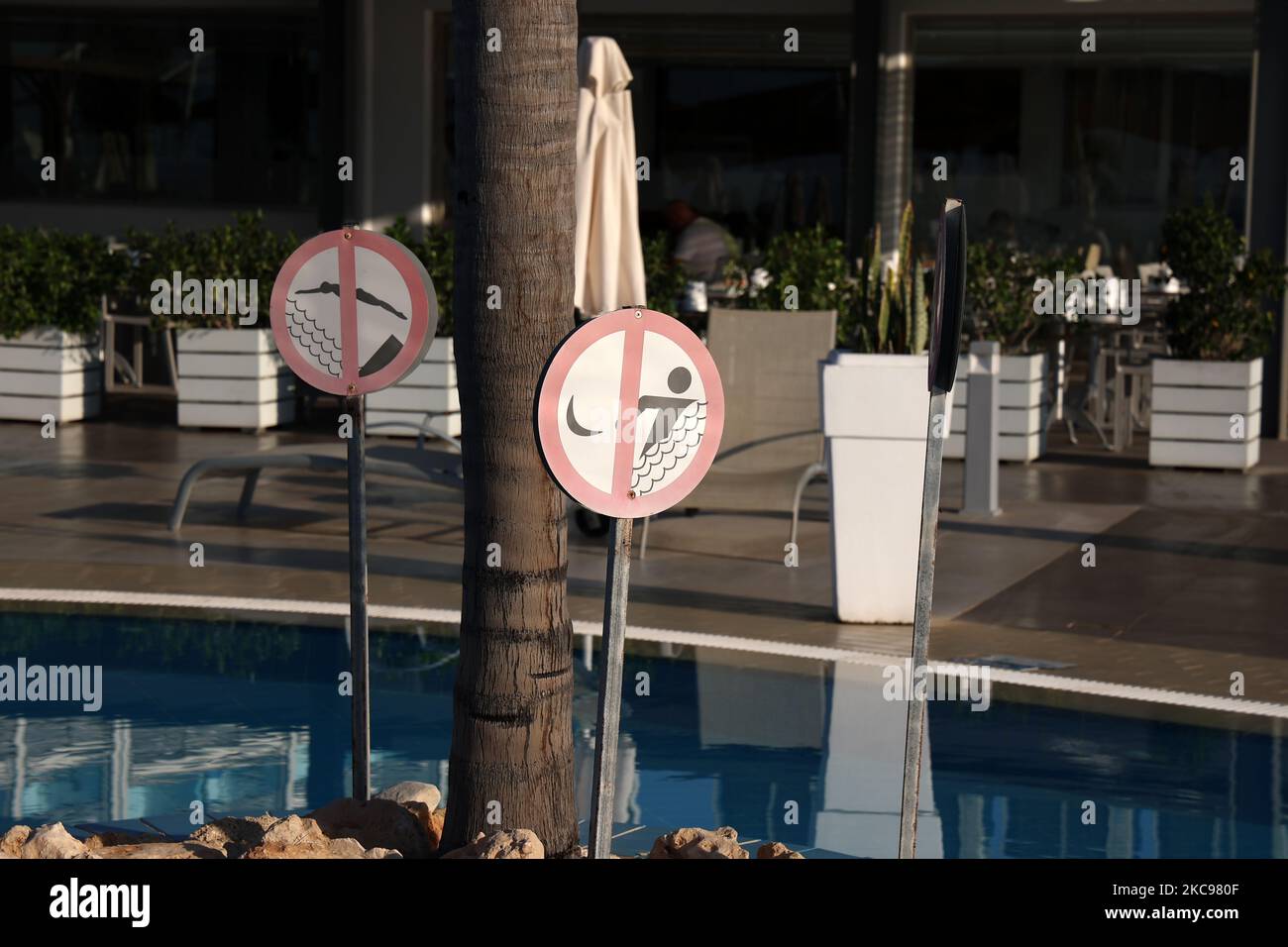 The warning signs against diving and night swimming at a public pool ...