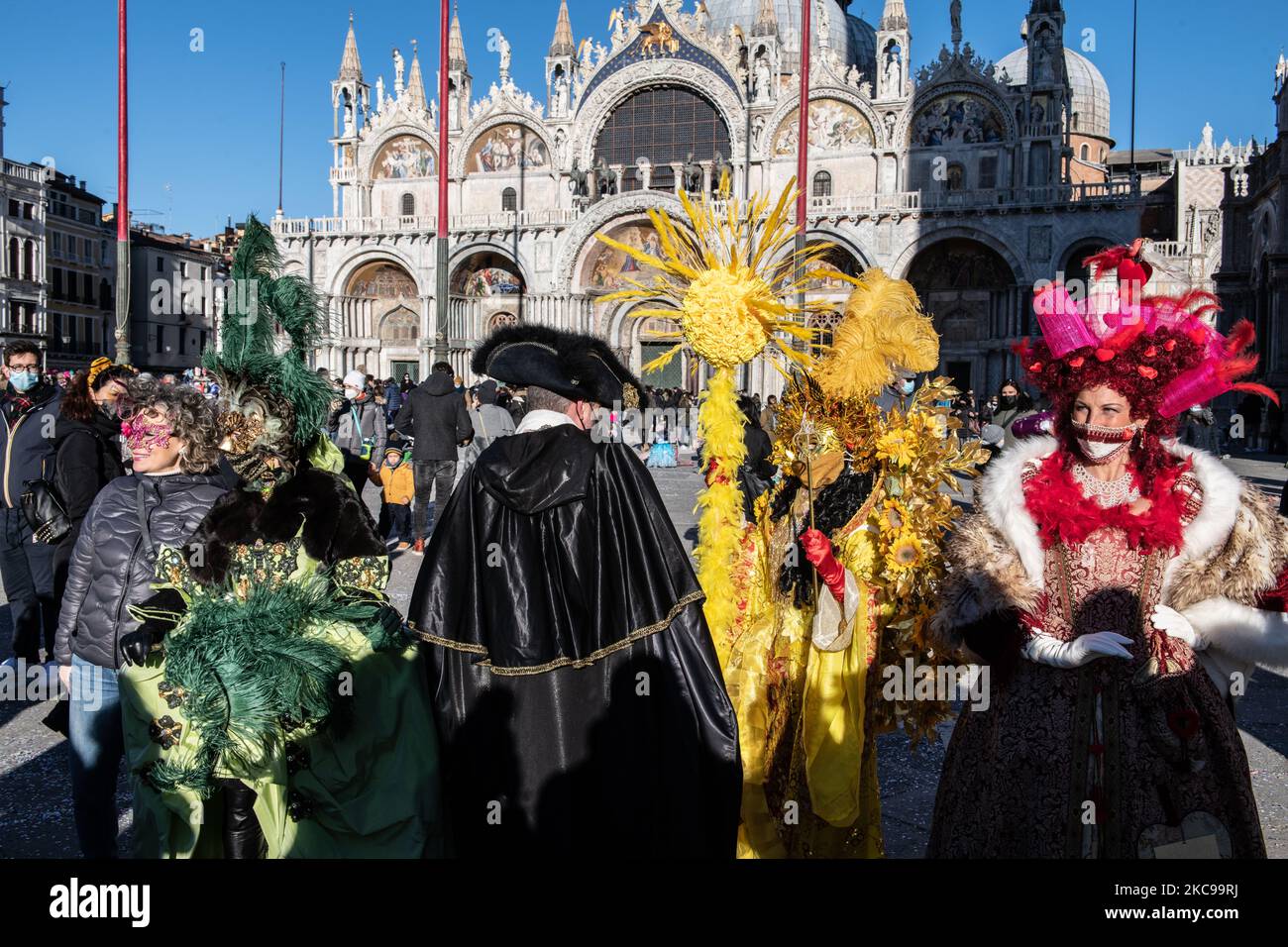 Tourists wear a Carnival costume and pose to be photographed by the ...