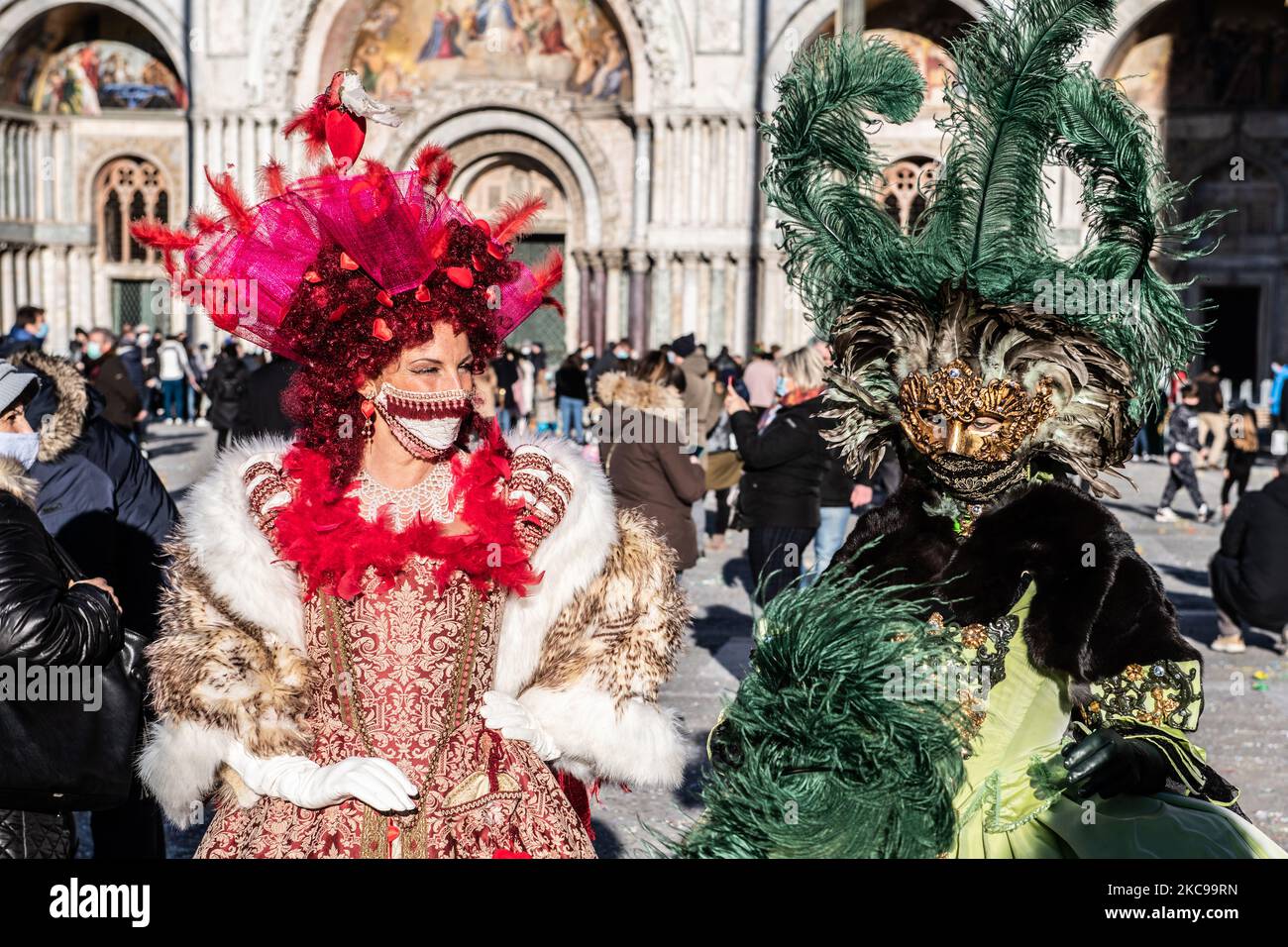 Tourists wear a Carnival costume and pose to be photographed by the ...