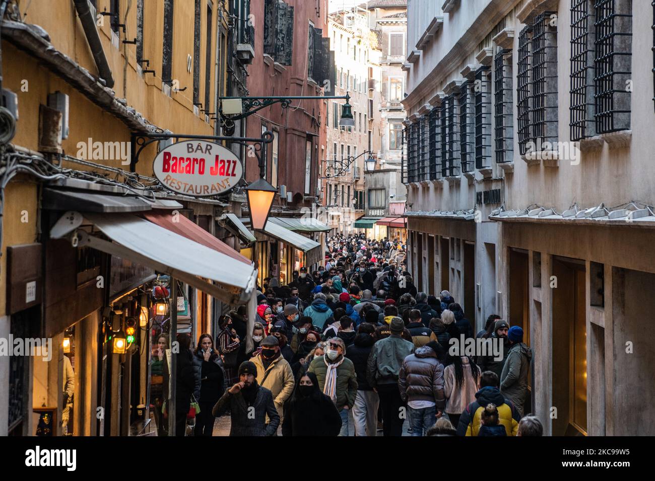 A crowded street in Venice with people walking not respecting the rules ...