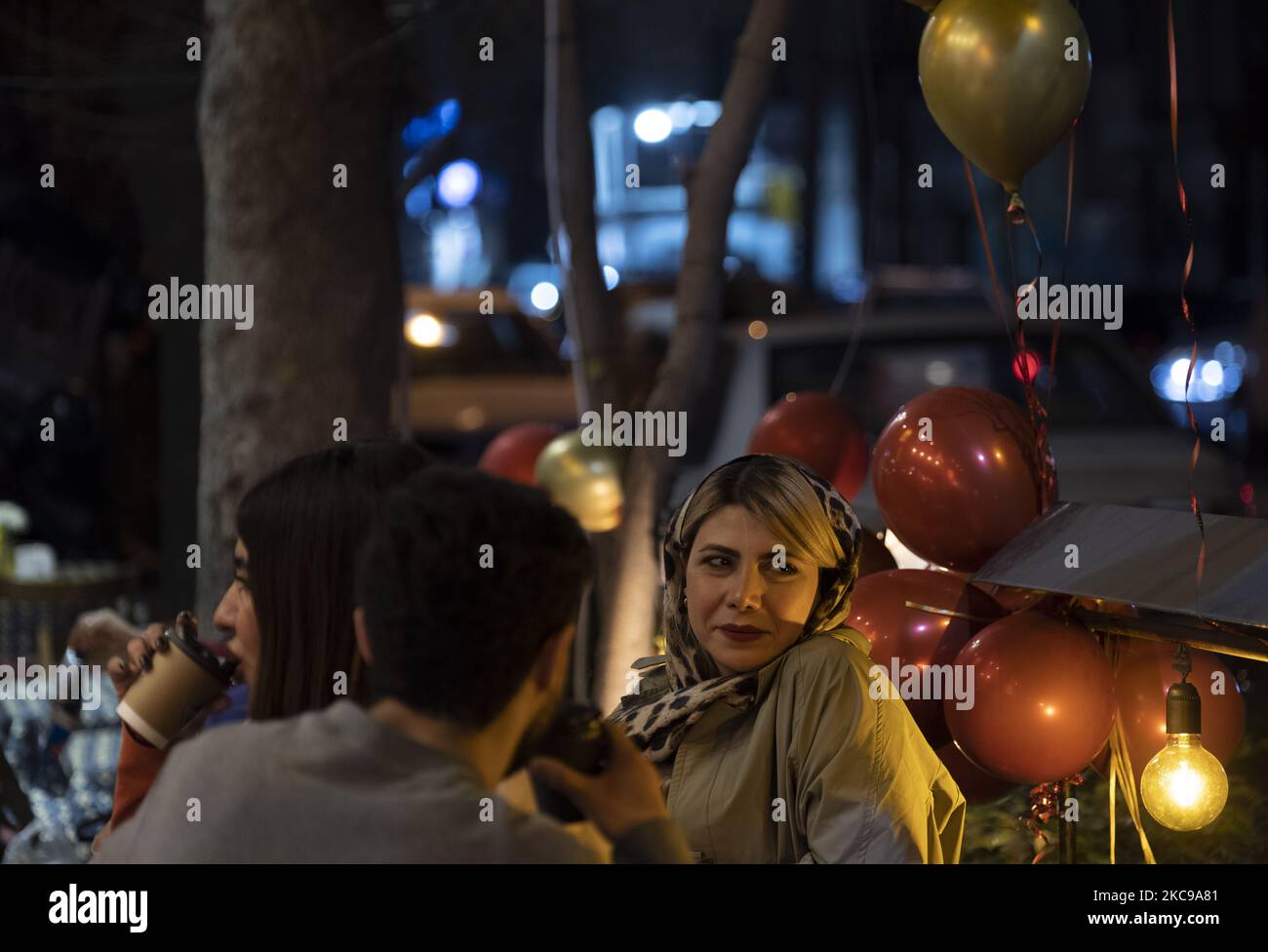 Iranian youth sit out of a cafe on Valentine’s day in downtown Tehran ...