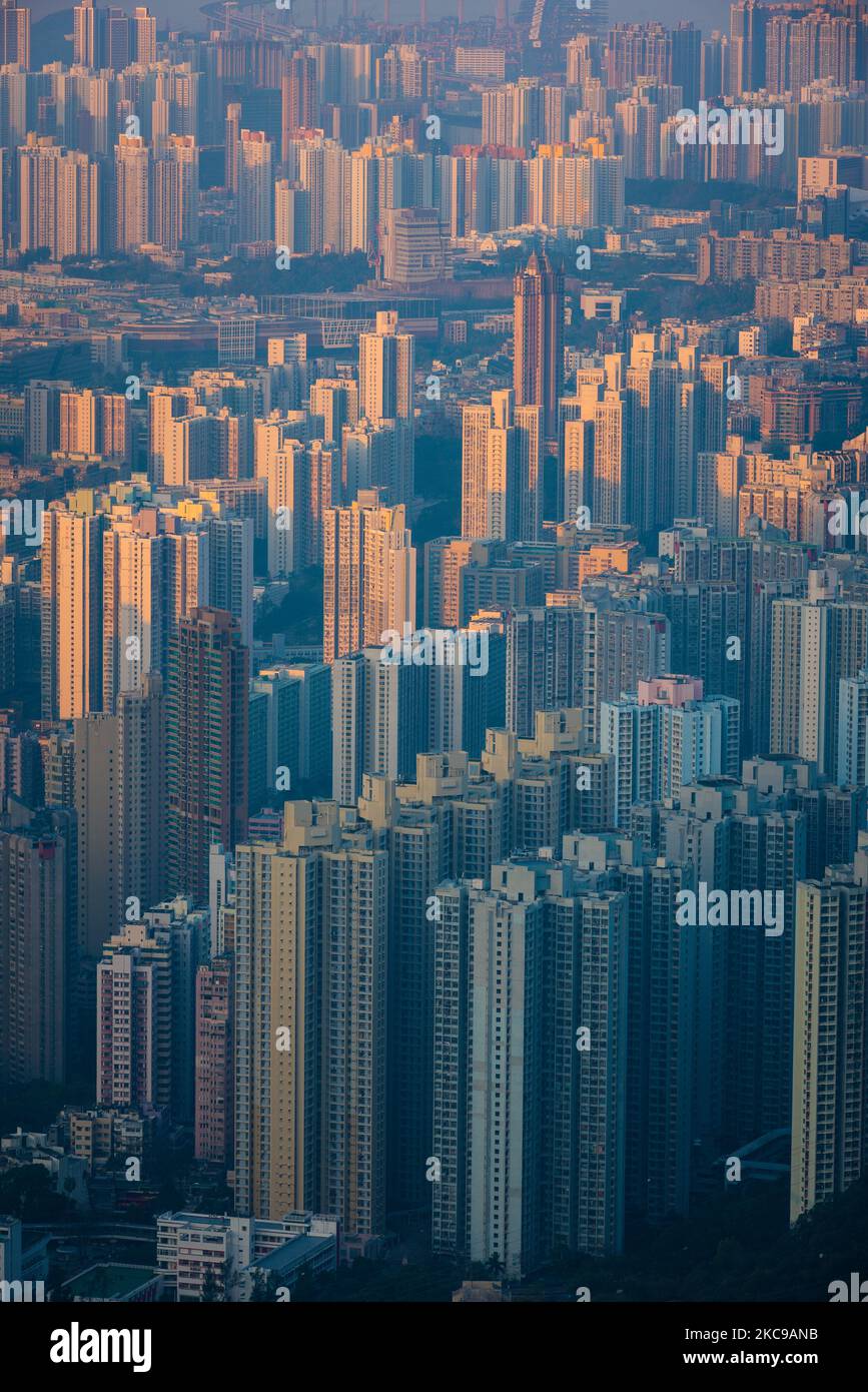 The sunrise shines over the high-rises in Kowloonin Hong Kong, China ...