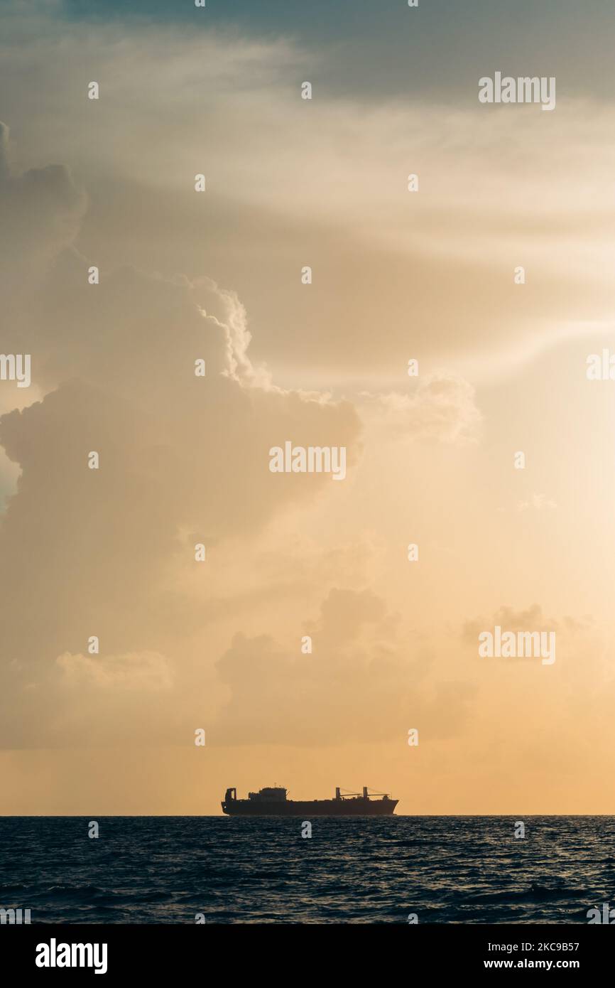 An aerial view of boat floating in sea during sunset Stock Photo - Alamy