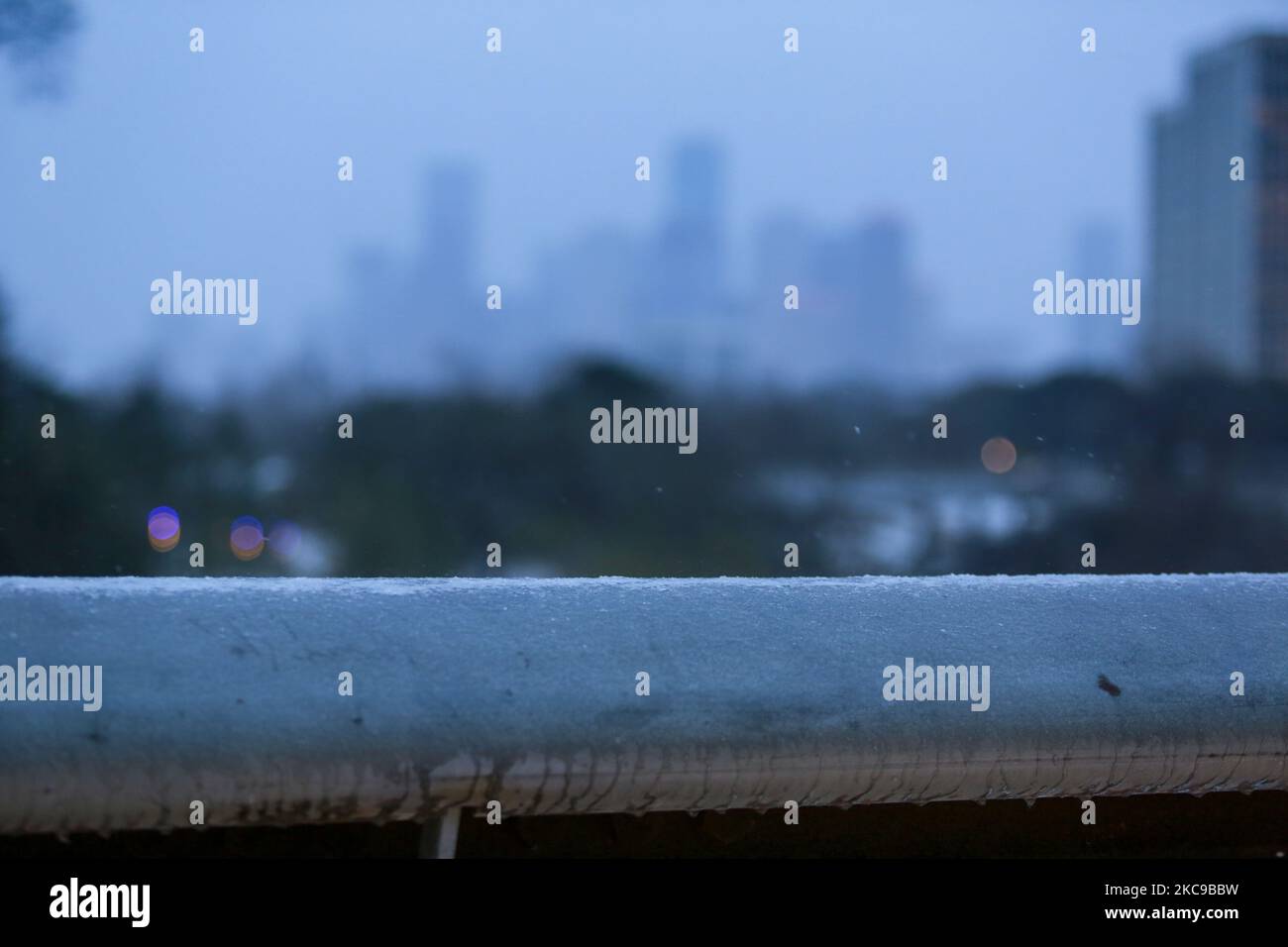 The Houston Skyline behind an icy bridge in Buffalo Bayou Park early on ...