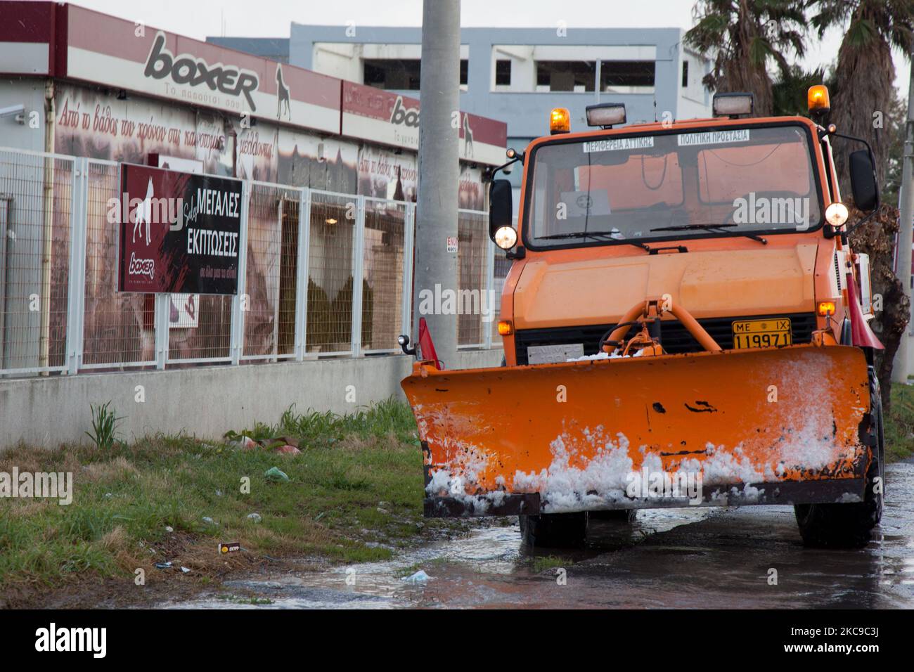 A snow plow is at the side of the road ready to meddle in the roads to ...