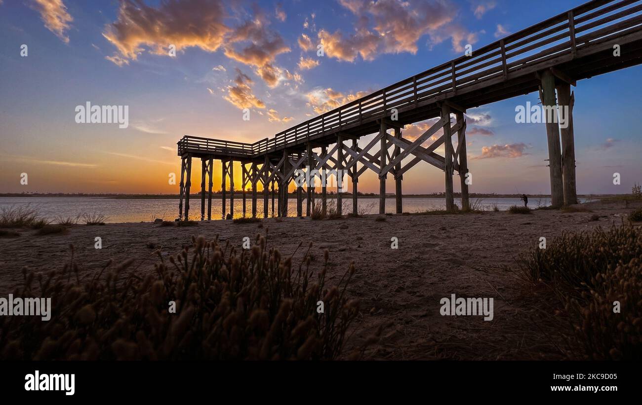 An aerial view of dock over lake during sunset Stock Photo - Alamy