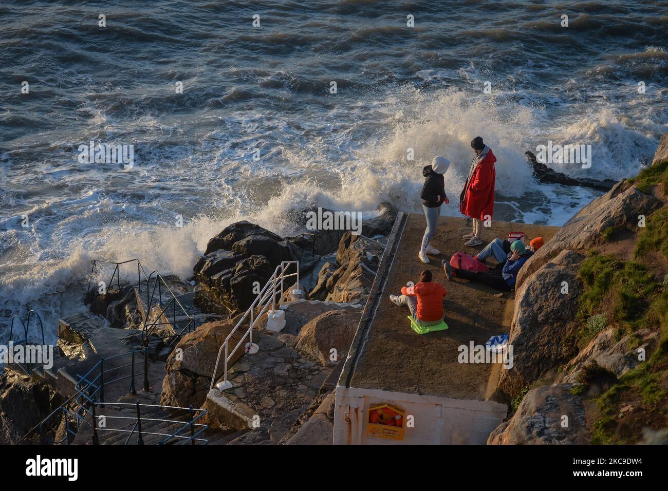 People observe the rough seas at Vico's Bathing Site, Hawk Cliff in ...