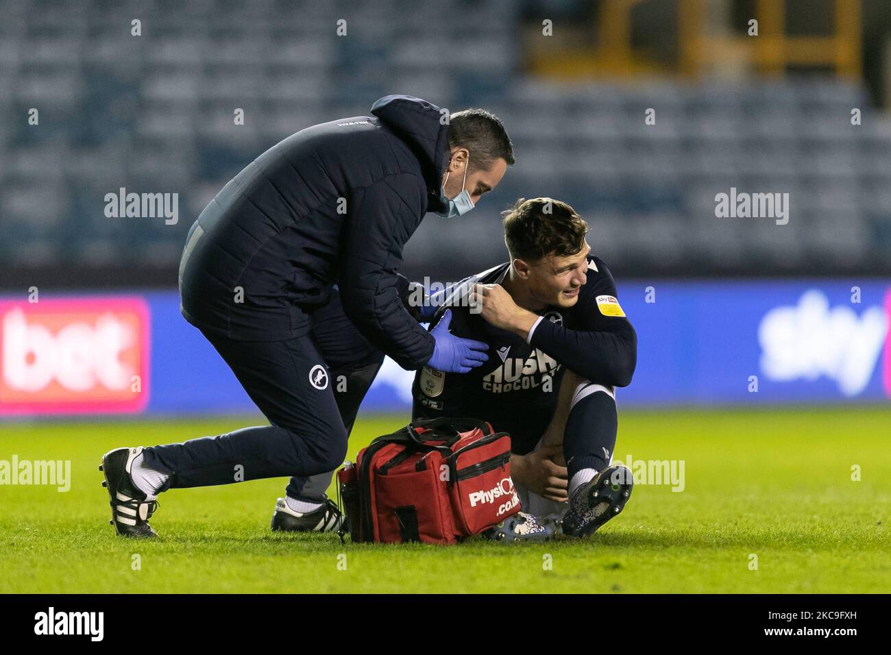 Jake Cooper of Millwall is attended to by medics during the Sky Bet ...