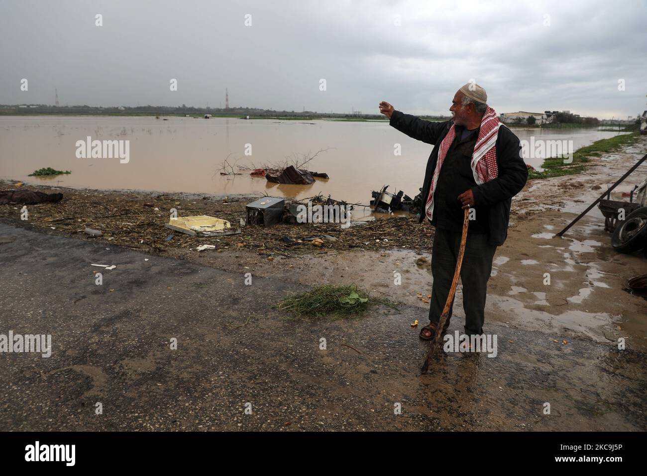 A Palestinian farmer inspects his agricultural field after it was ...