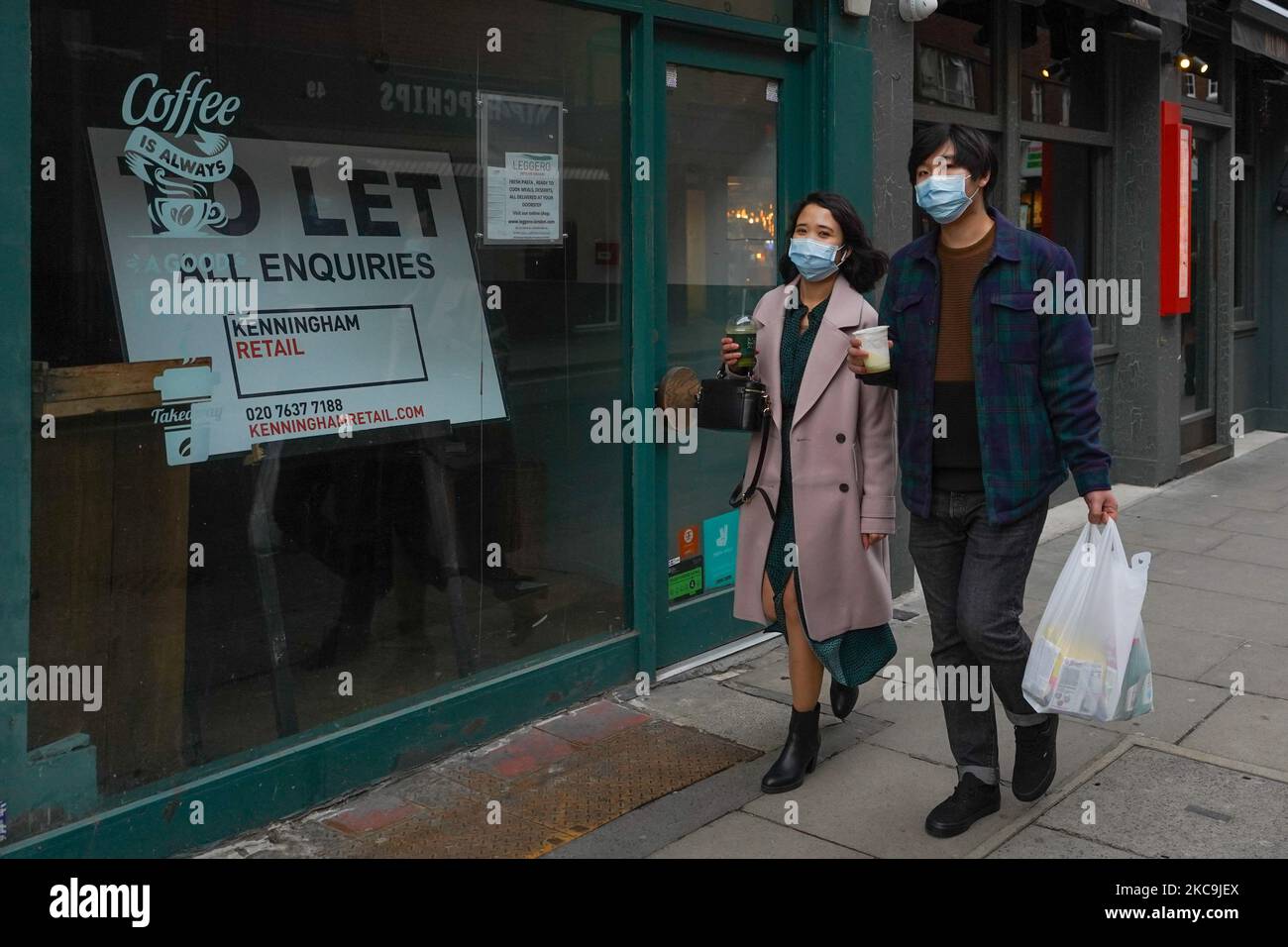 Shoppers wearing face masks walk through the streets of Westminster in ...