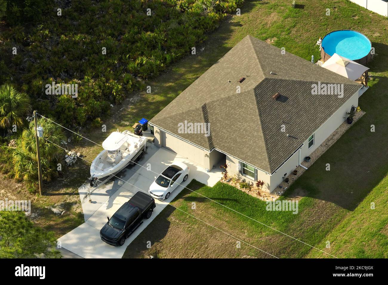 Aerial view of typical contemporary american private house with roof ...
