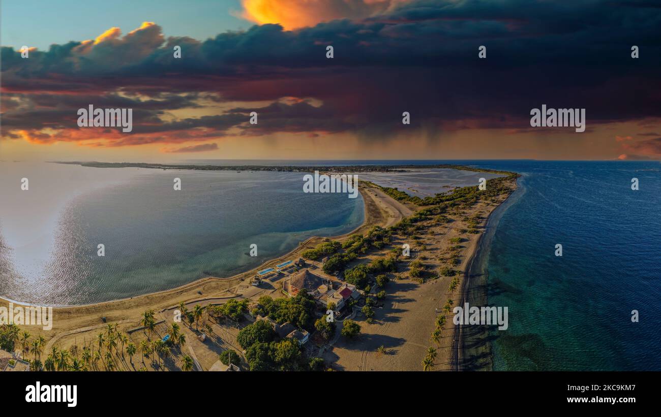 A beautiful sunset with a dramatic cloudy sky in front of the sea ...