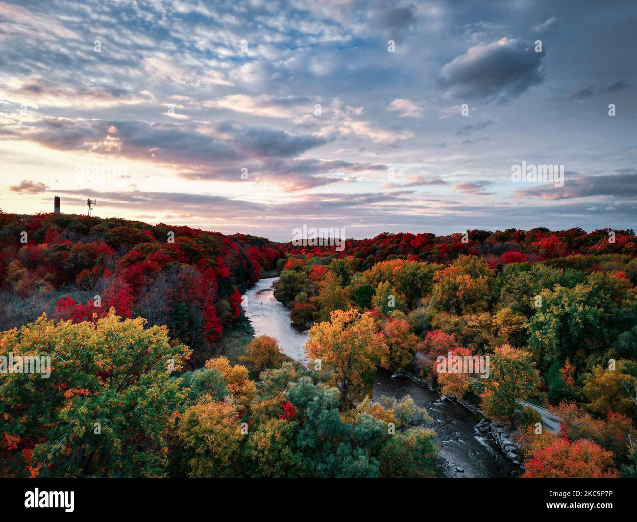 Charming scene of sunrise sky over peaceful river and colorful autumn ...