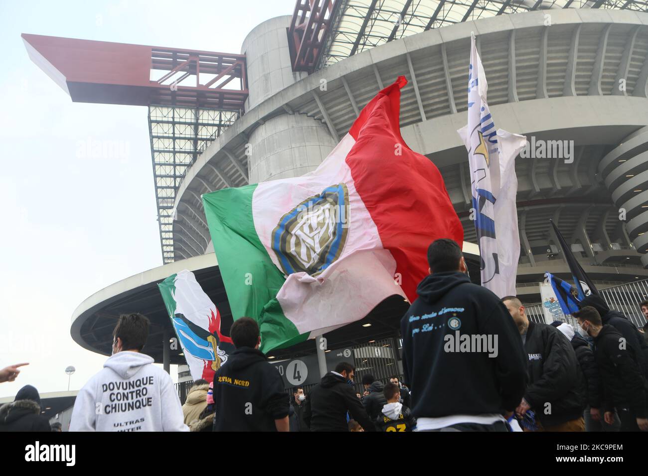 Fans of AC Milan and FC Internazionale wait outside the stadium ...