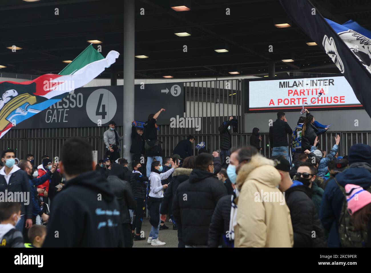 Fans of AC Milan and FC Internazionale wait outside the stadium ...