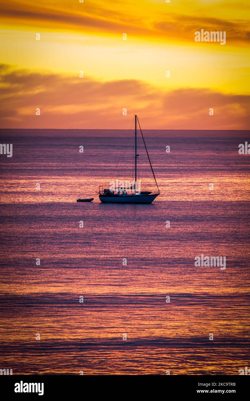 An aerial view of boat floating in sea during sunset Stock Photo - Alamy
