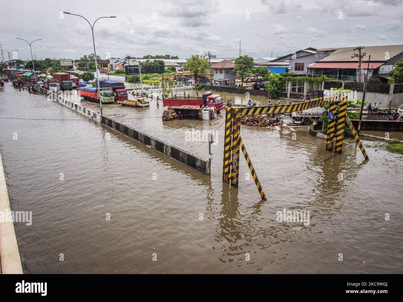 A traffic jam and accident on a road that was flooded with floodwaters ...