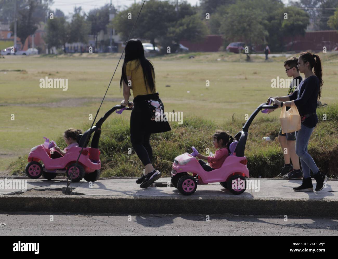Women carry carts with children outside the Bosque de Tláhuac where ...