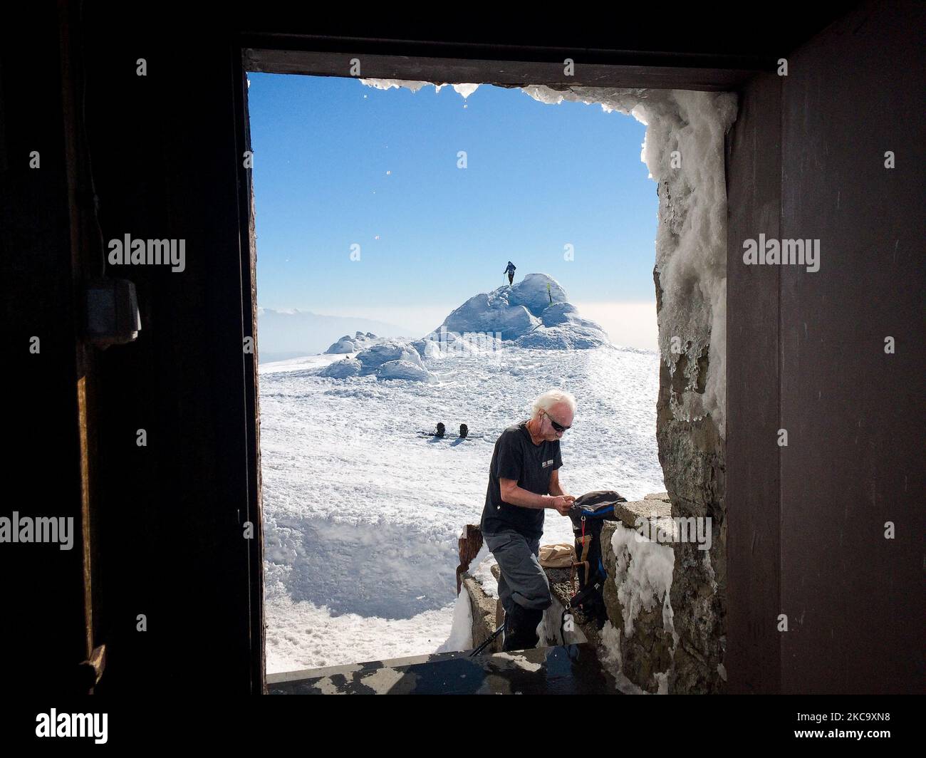 Winter tourists are preparing for their descent from Cherni vrah peak ...