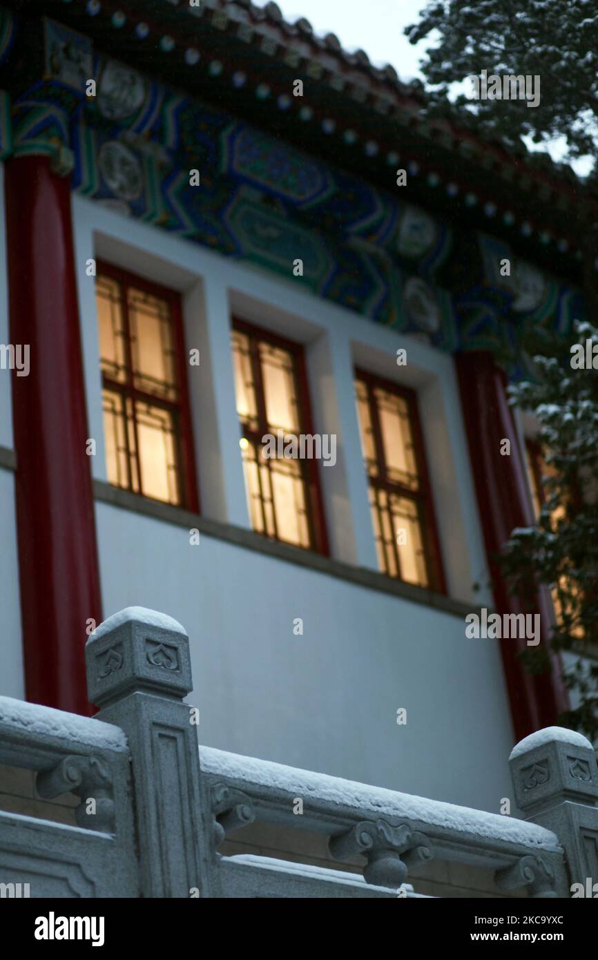 A vertical shot of a traditional Chinese house with ornamented fencing ...