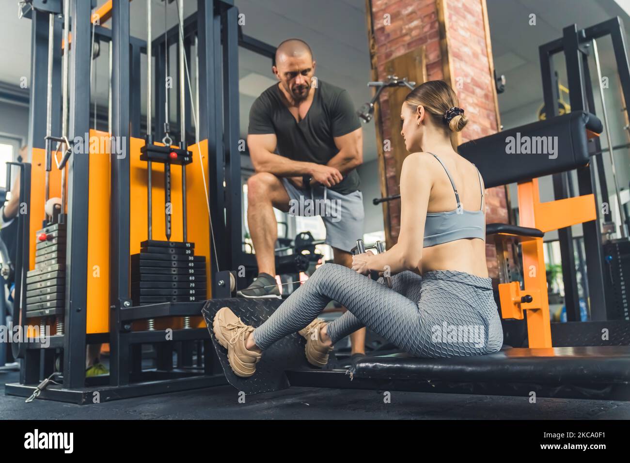 Fitness test with personal trainer. Stylish skinny caucasian girl in ...