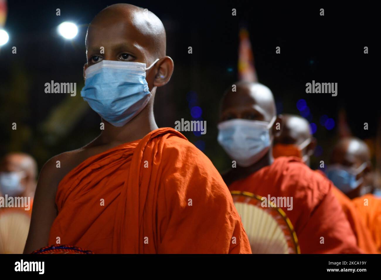 Sri Lankan Buddist mank wearing a face mask attending to Nawam Perahara ...