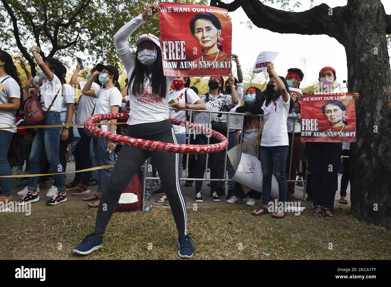 Myanmar demonstrator holds a portrait of Aung San Suu Kyi during a ...