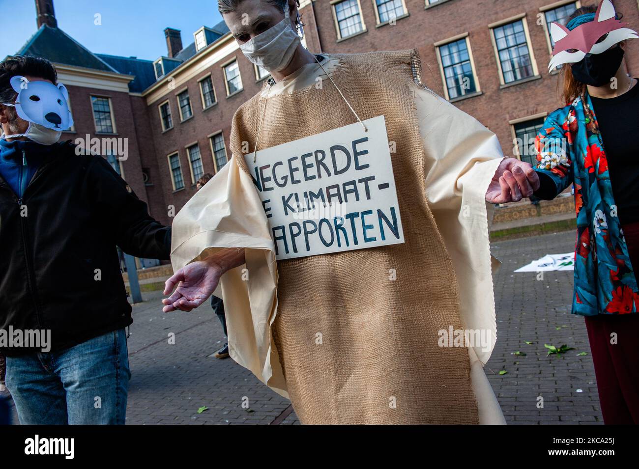 Climate activists wearing animal dresses are taking care of the group ...